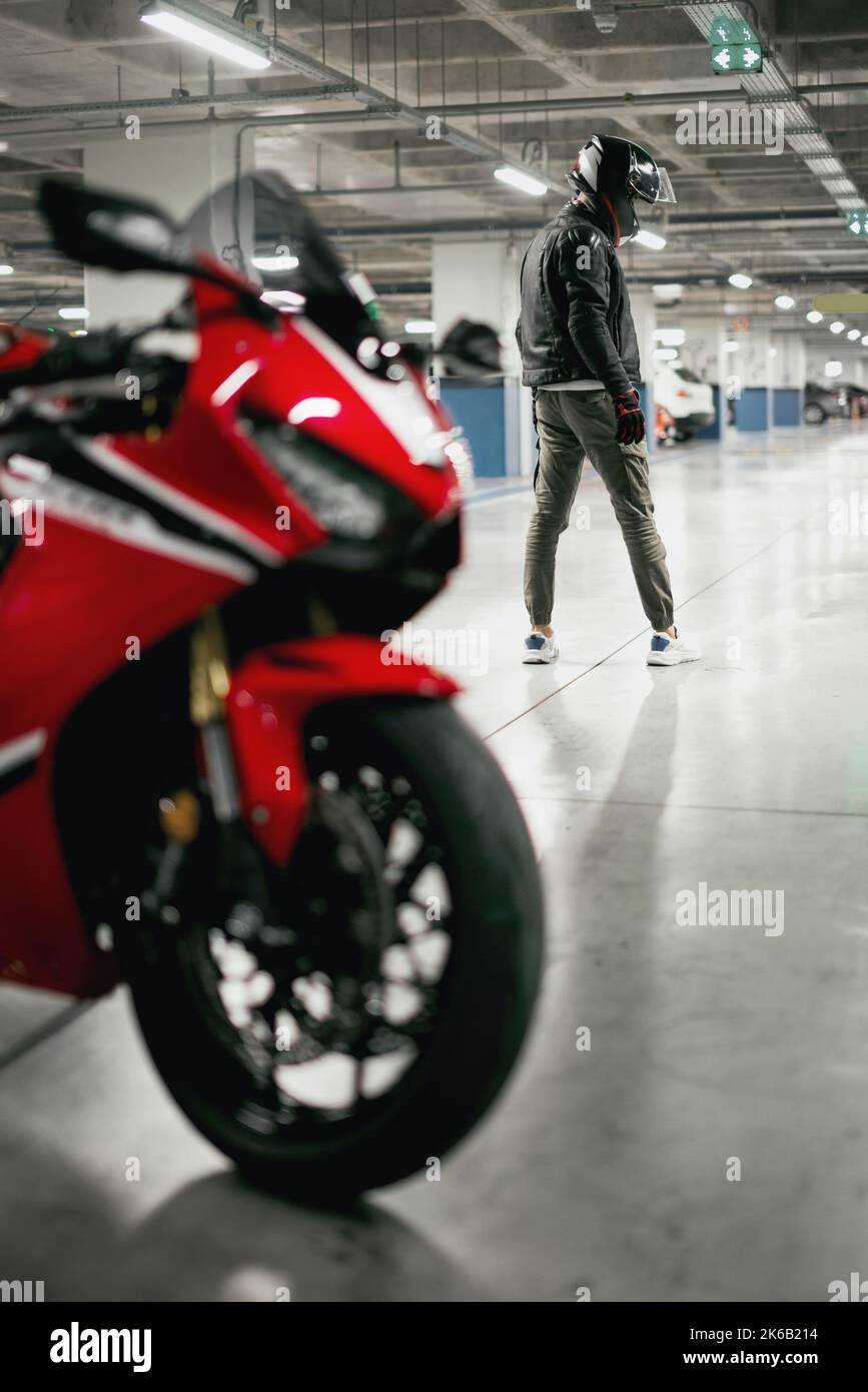 Back view of a motorcycle rider with a helmet and defocused race ...
