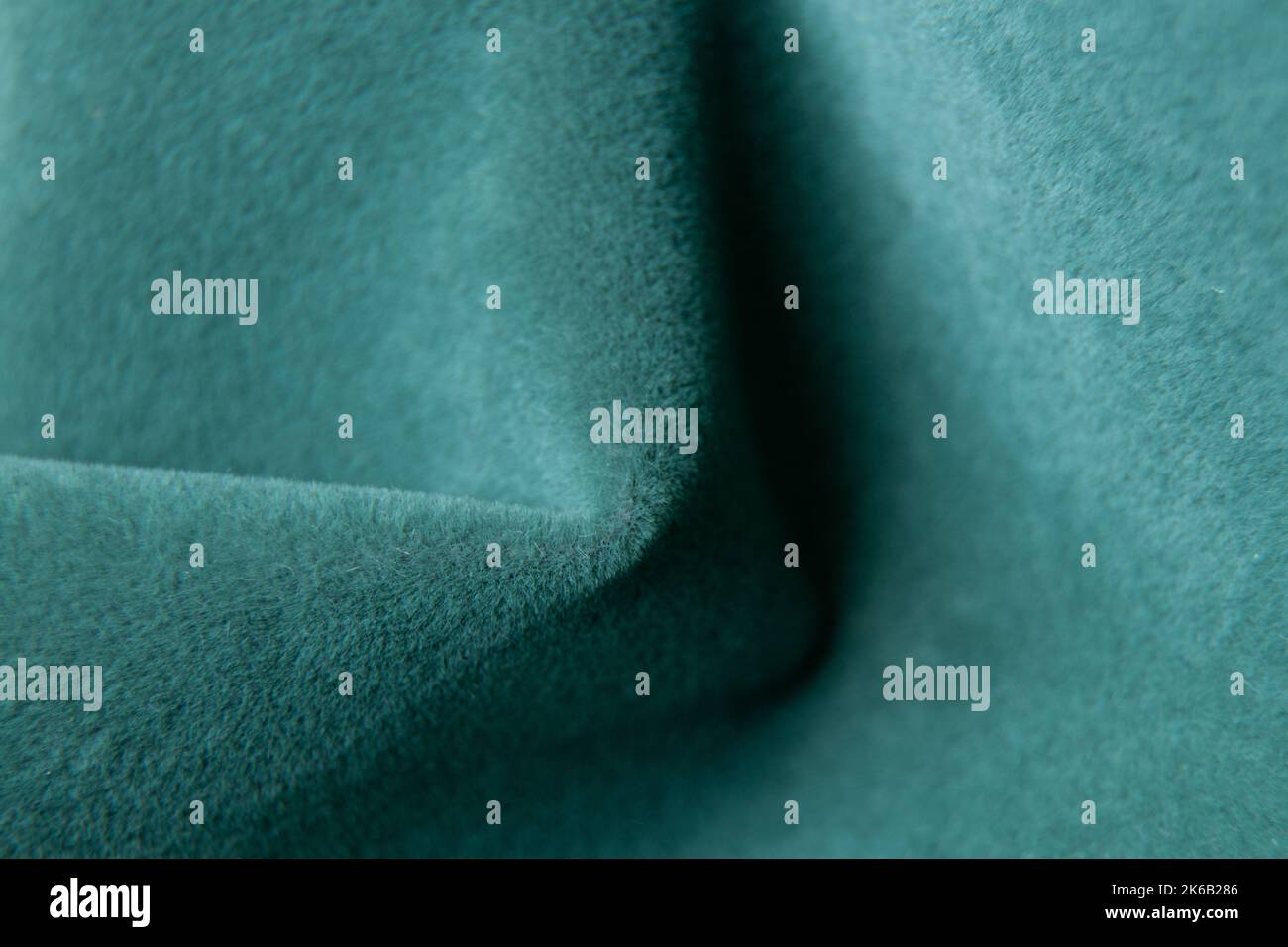 Green fabric as a background, velor soft fabric, green wrinkled fabric ...