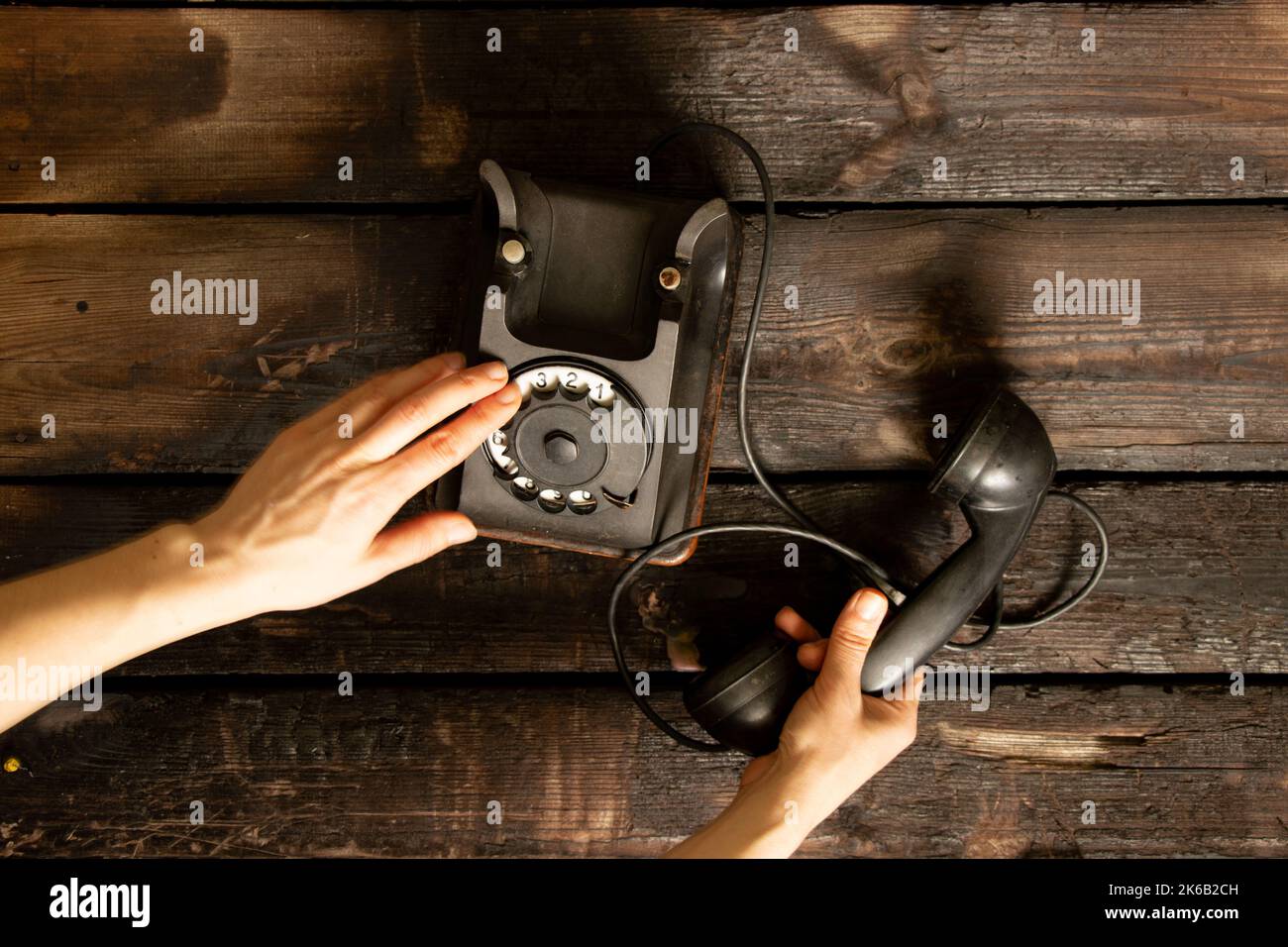 Old retro phone black and woman's hand closeup,call on the phone ...