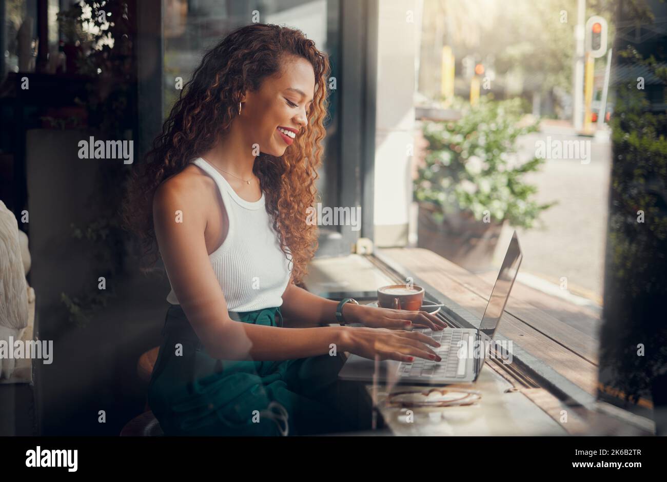 Coffee, laptop, and black woman typing an email while working at a ...