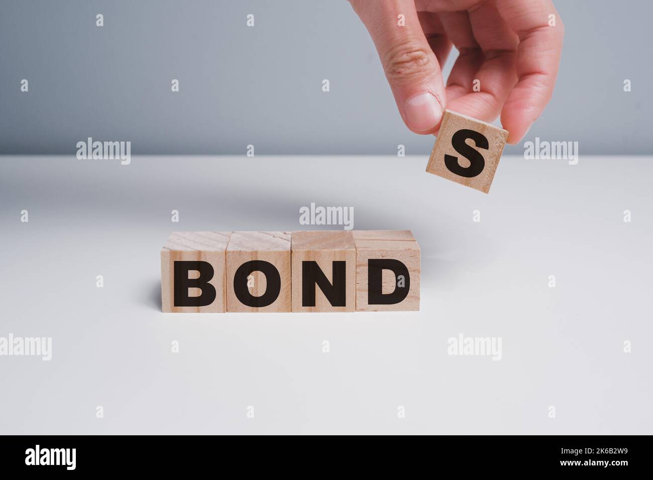 Concept of bonds. Businessman puts wooden blocks with the word Bonds ...
