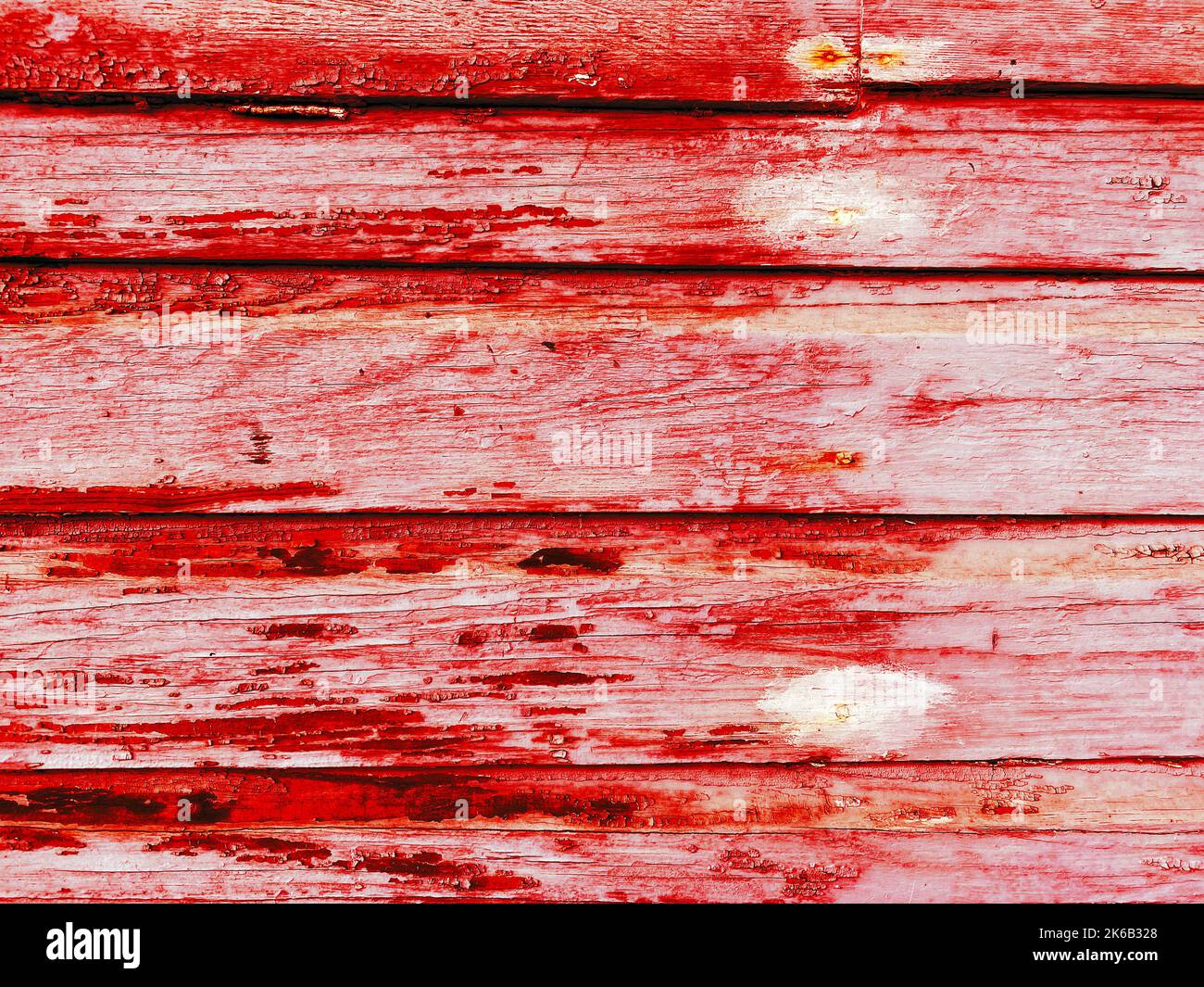 a close-up view of a faded red rustic wood wall, showcasing weathered ...