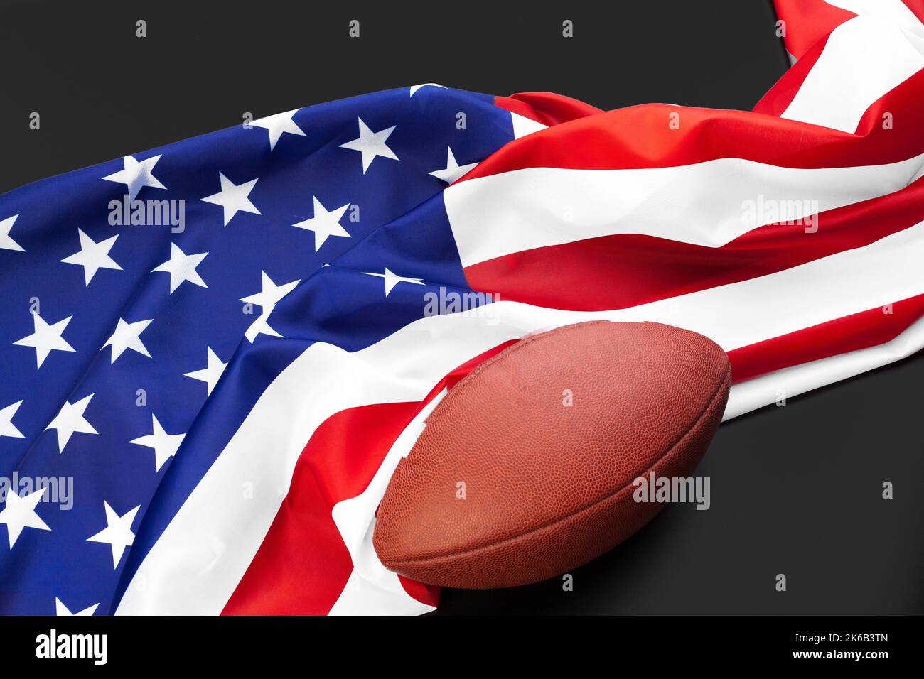 American football ball and american flag on table close up Stock Photo ...