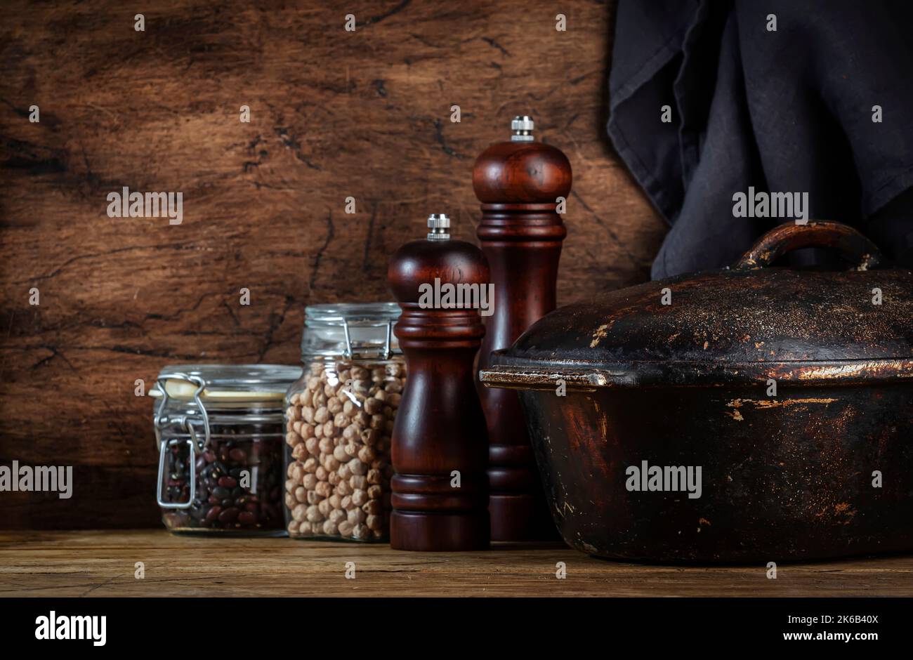 Cooking food background: rustic wood kitchen table, cast iron pan ...