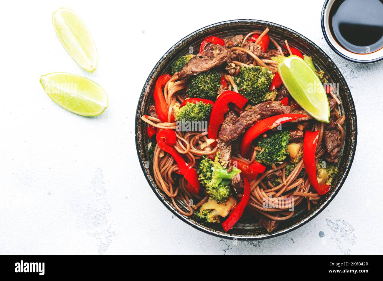Stir fry noodles with vegetables and beef, paprika and broccoli with ...