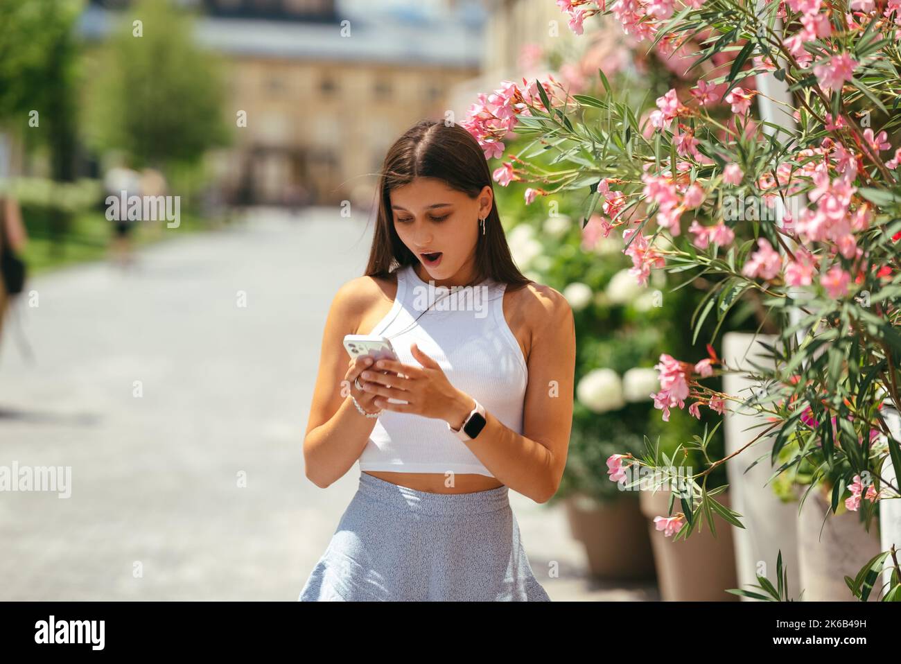 Pretty woman an urban street to read an sms on her mobile phone Stock ...