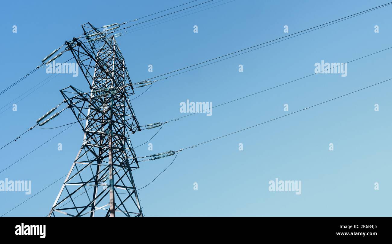 Steel power pylon construction with high voltage cables against blue ...