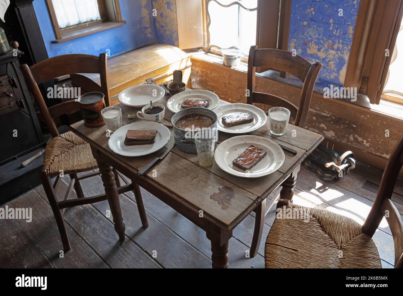 The interior of a Dutch living room from the 1900s, food on the table ...