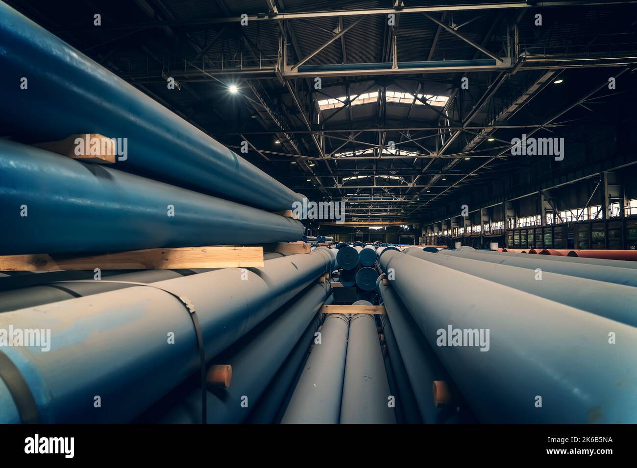 Group of blue metal pipes for water in metallurgical factory warehouse ...