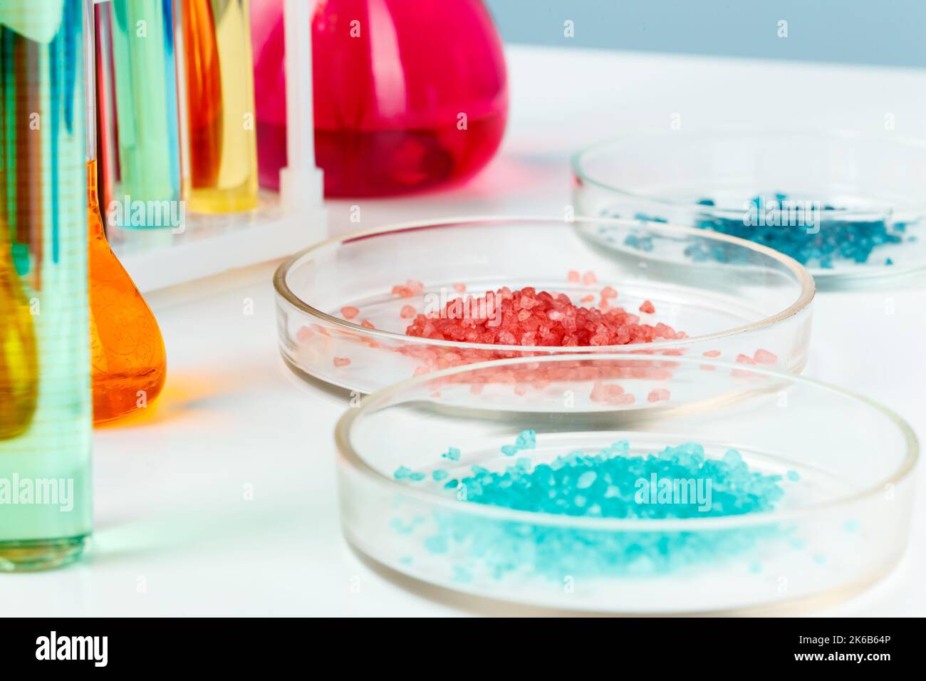 Colored liquids inside lab glassware on white table in laboratory Stock ...
