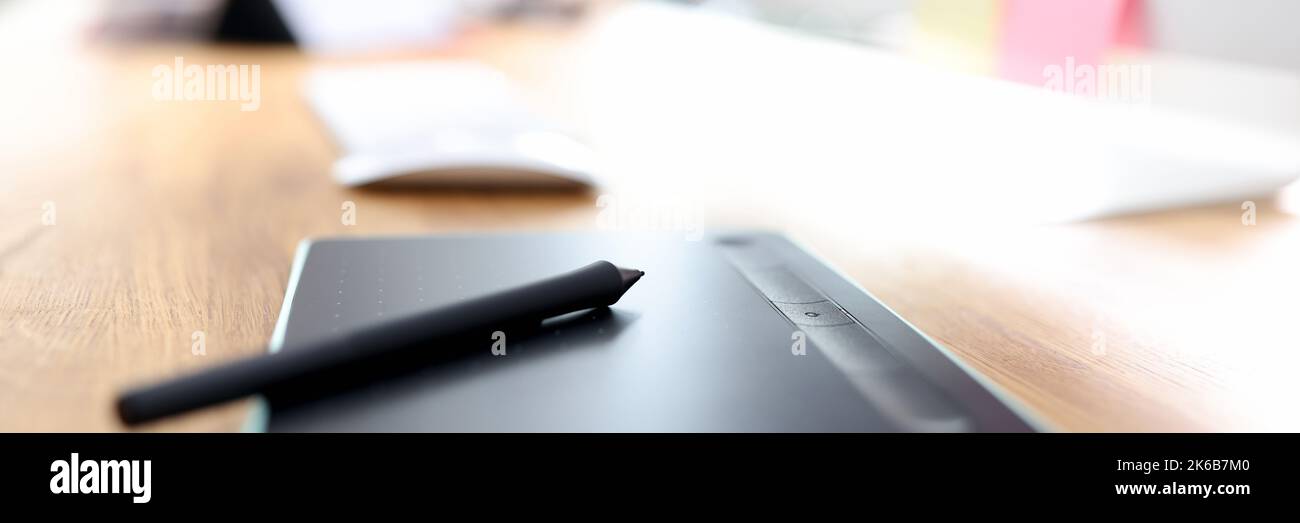 Graphic tablet and stylus on designer desktop closeup Stock Photo - Alamy
