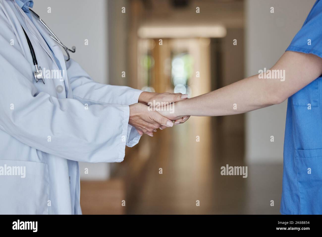 Its okay not to be okay. two unrecognizable doctors holding hands at a ...