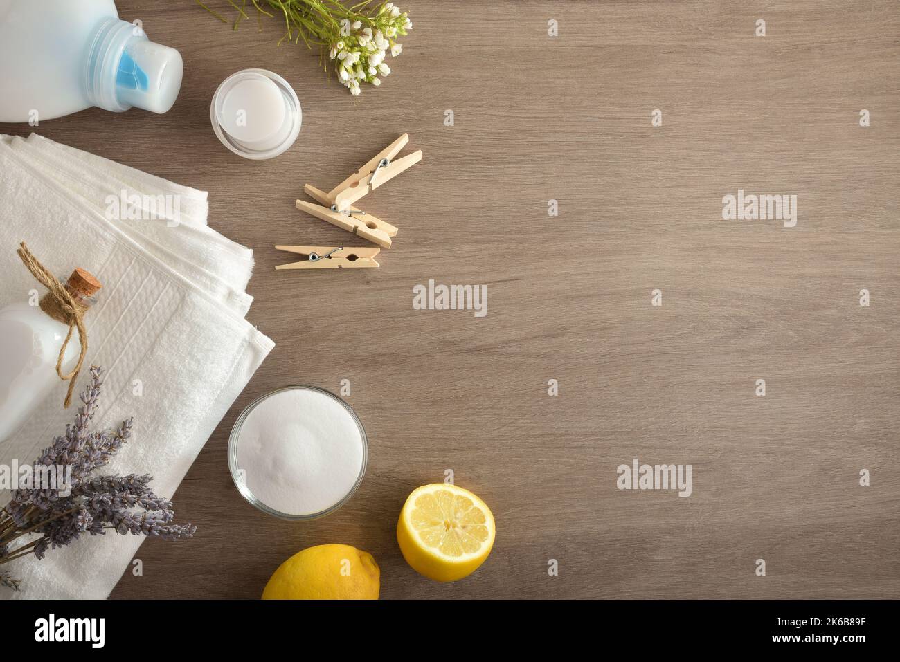 Clothes washing background with towels and products on wooden table ...