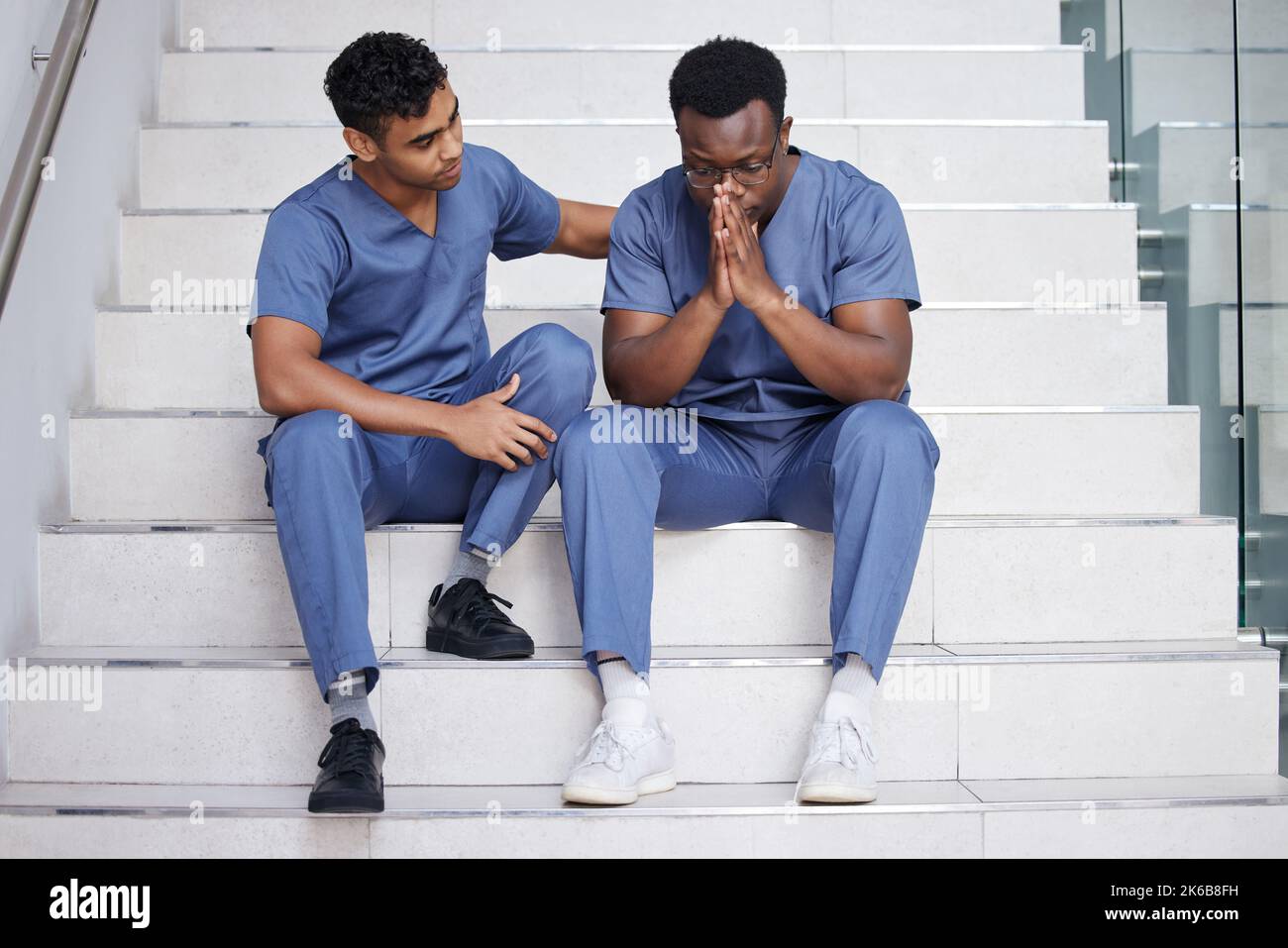You can talk to me. a young male doctor consoling a coworker at work ...