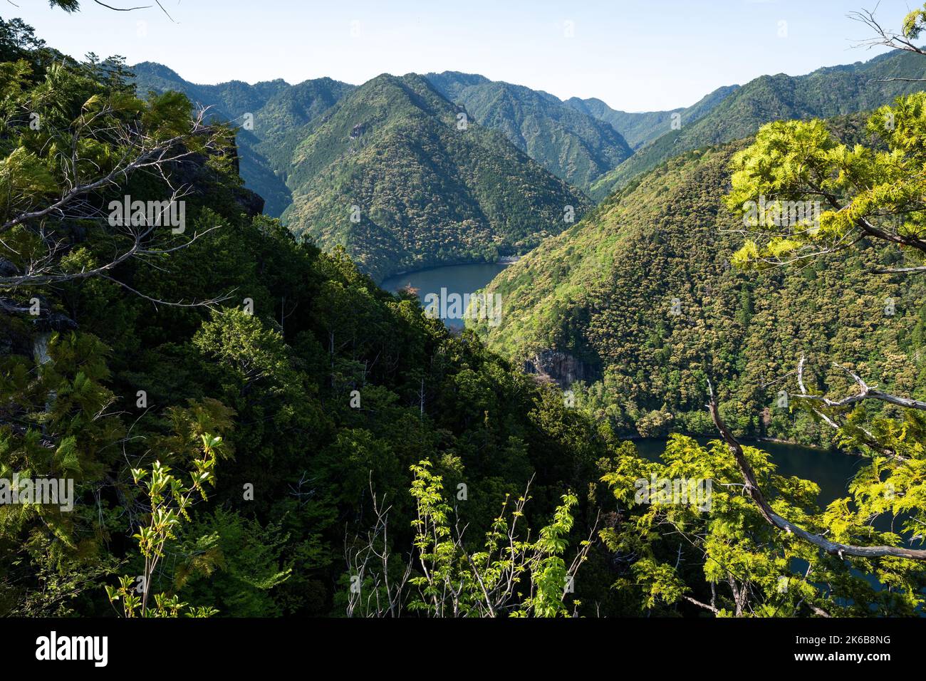 An aerial view of lakes between mountains covered with Shinshiro forest ...