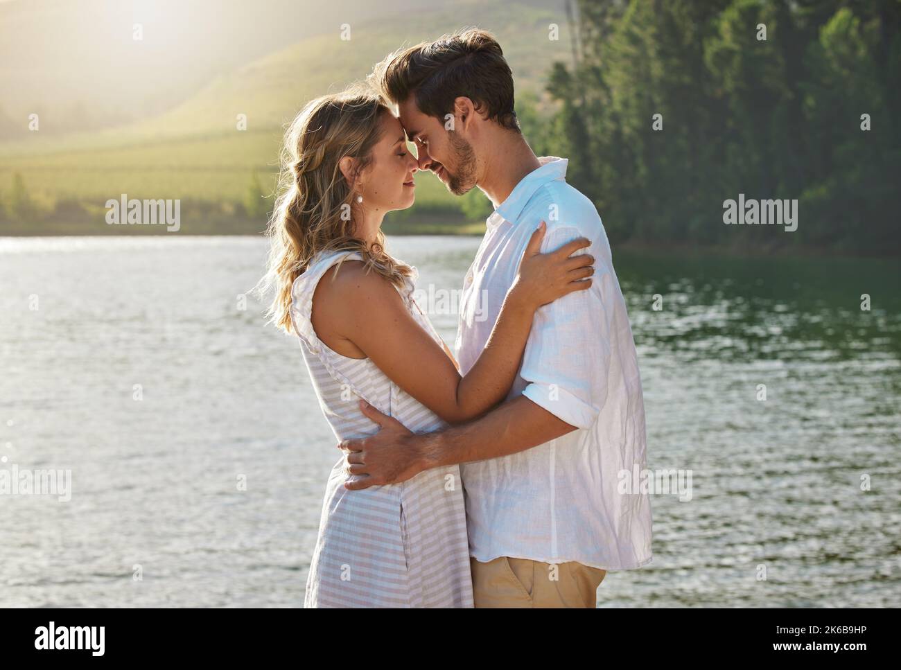 You are my source of peace and happiness. a young couple spending time together at a lake Stock ...