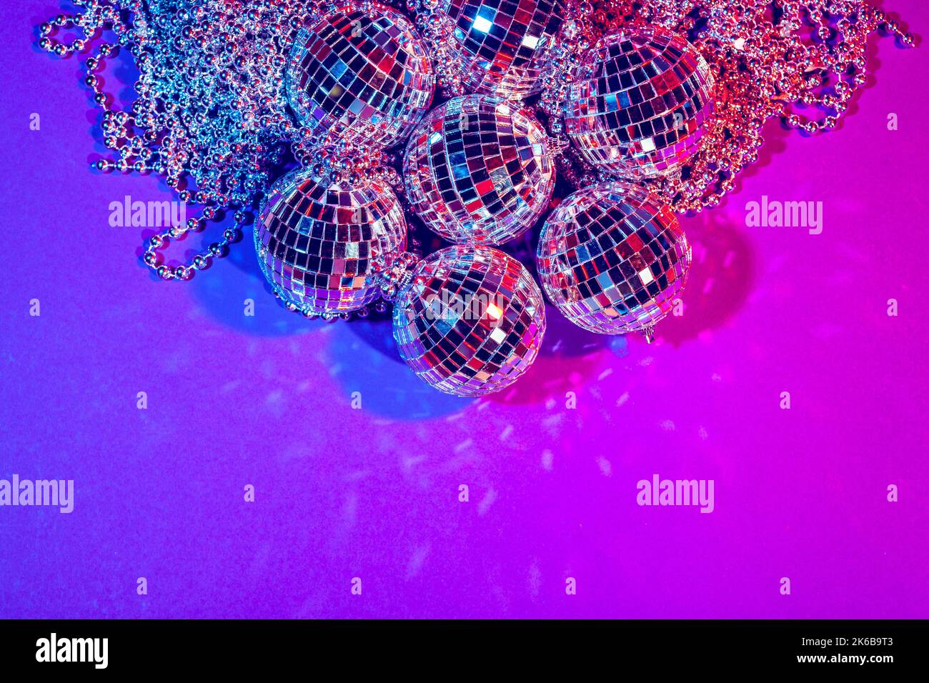 Shiny small disco balls sparkling in a beautiful purple light. Disco ...