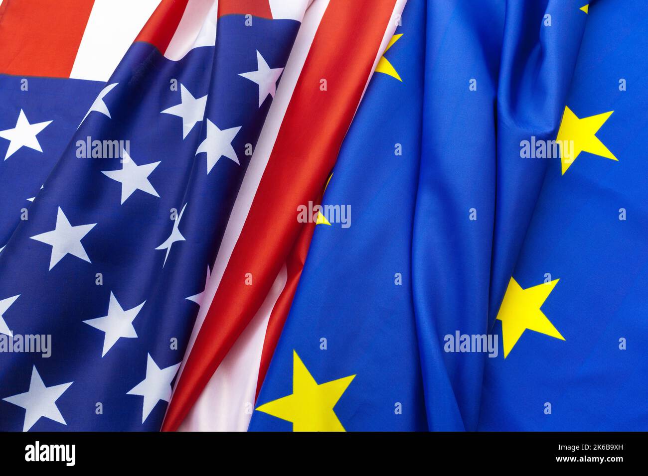 Closeup of Flags of USA and European Union lying together on table ...