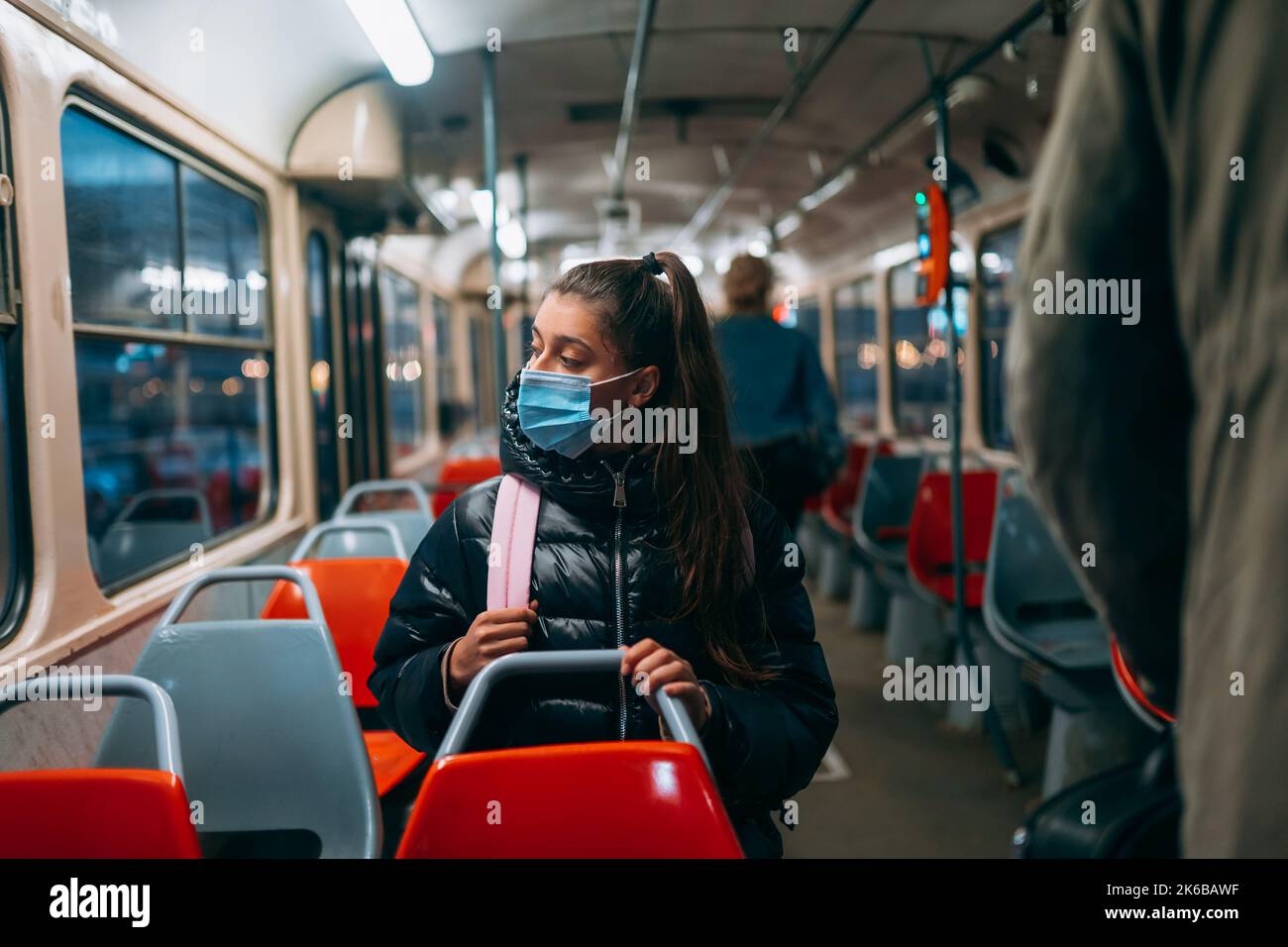 Young woman with mask traveling in the public transport Stock Photo - Alamy