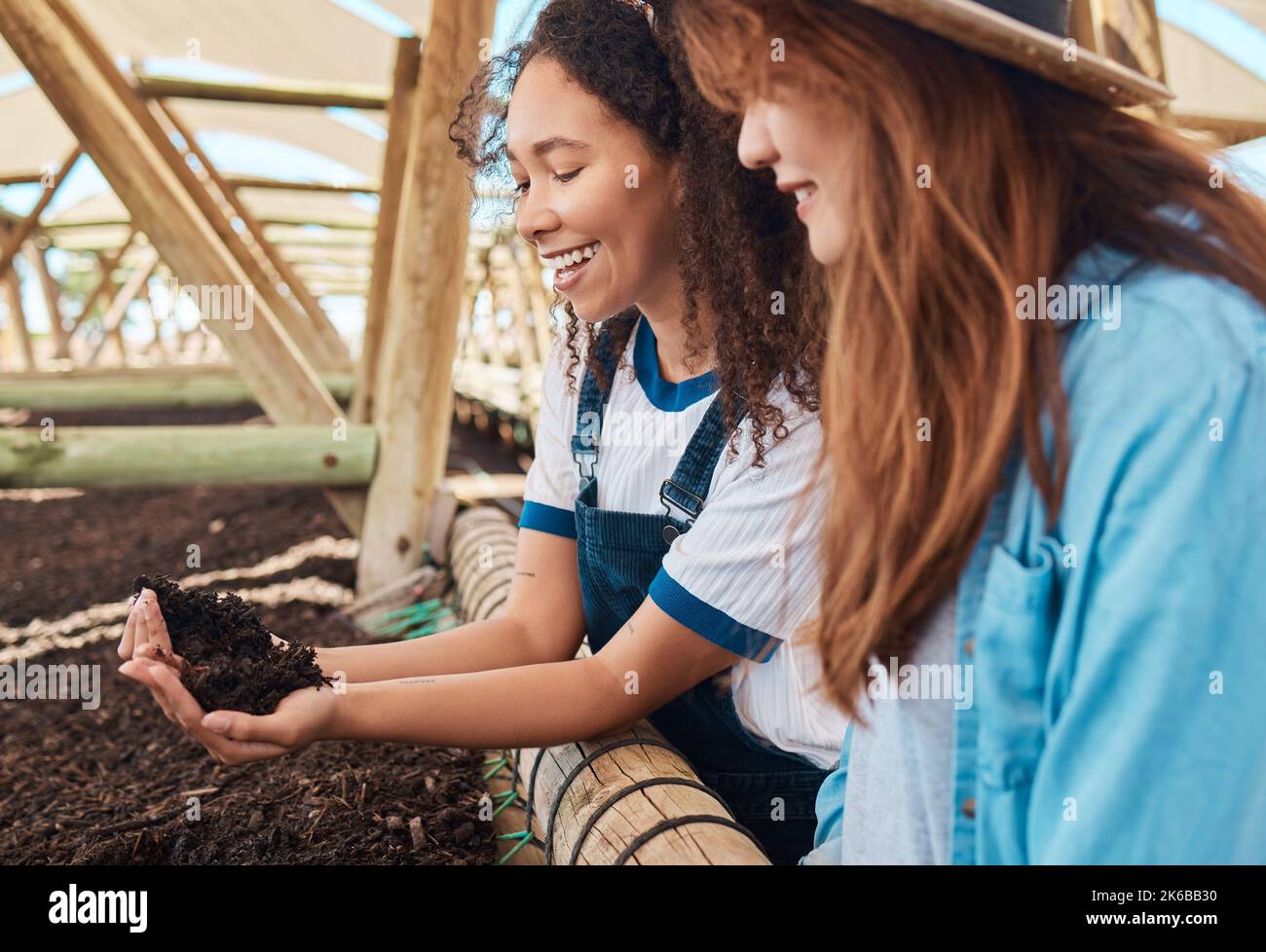 Improving the drainage of soil. two young woman inspecting soil while ...