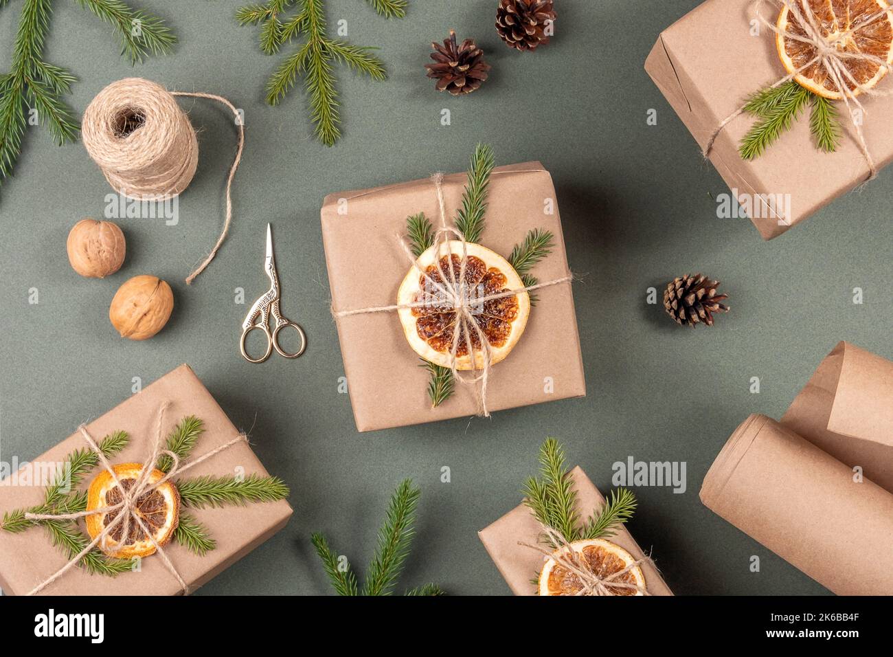 Boxes, craft paper, twine, scissors, dried oranges and natural decor ...