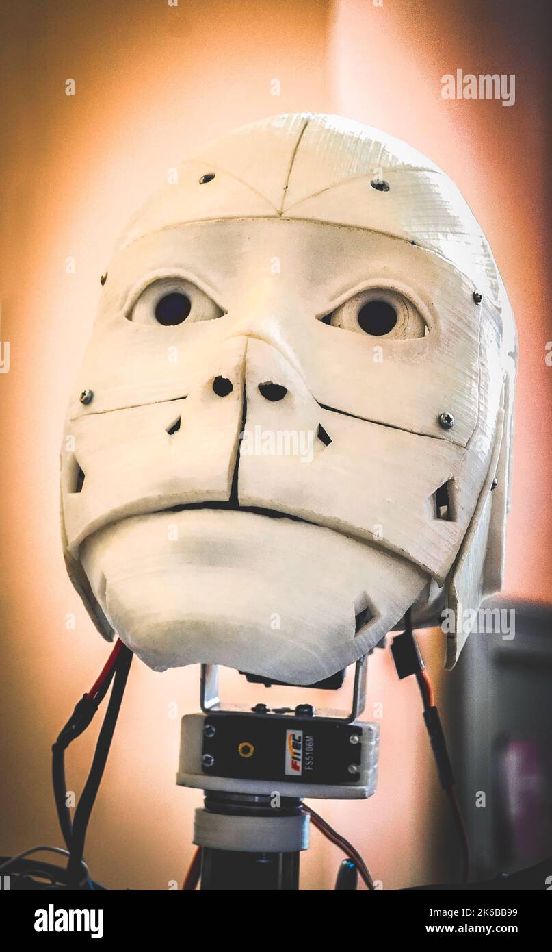 Face robot close-up. Face of an old robot made of white shabby plastic ...