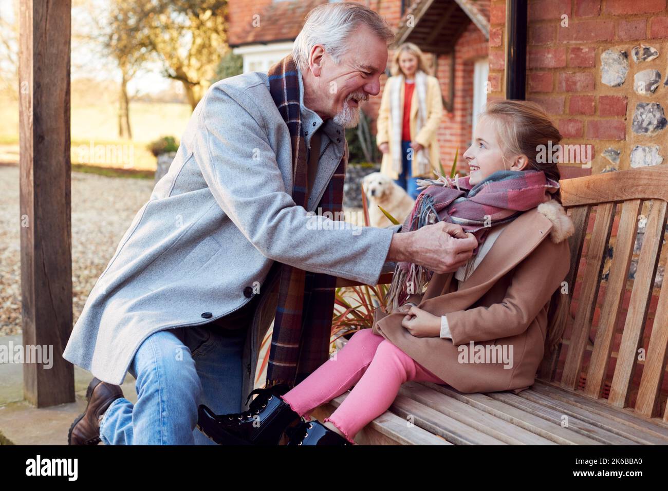 Grandparents With Granddaughter Outside House Getting Ready To Go For ...