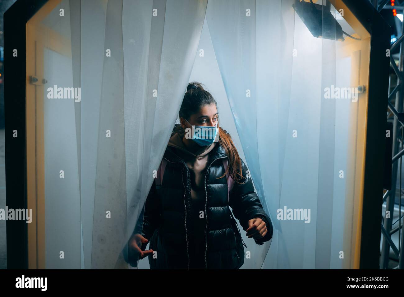 Woman at medic mask is staying in a disinfection tunnel Stock Photo - Alamy