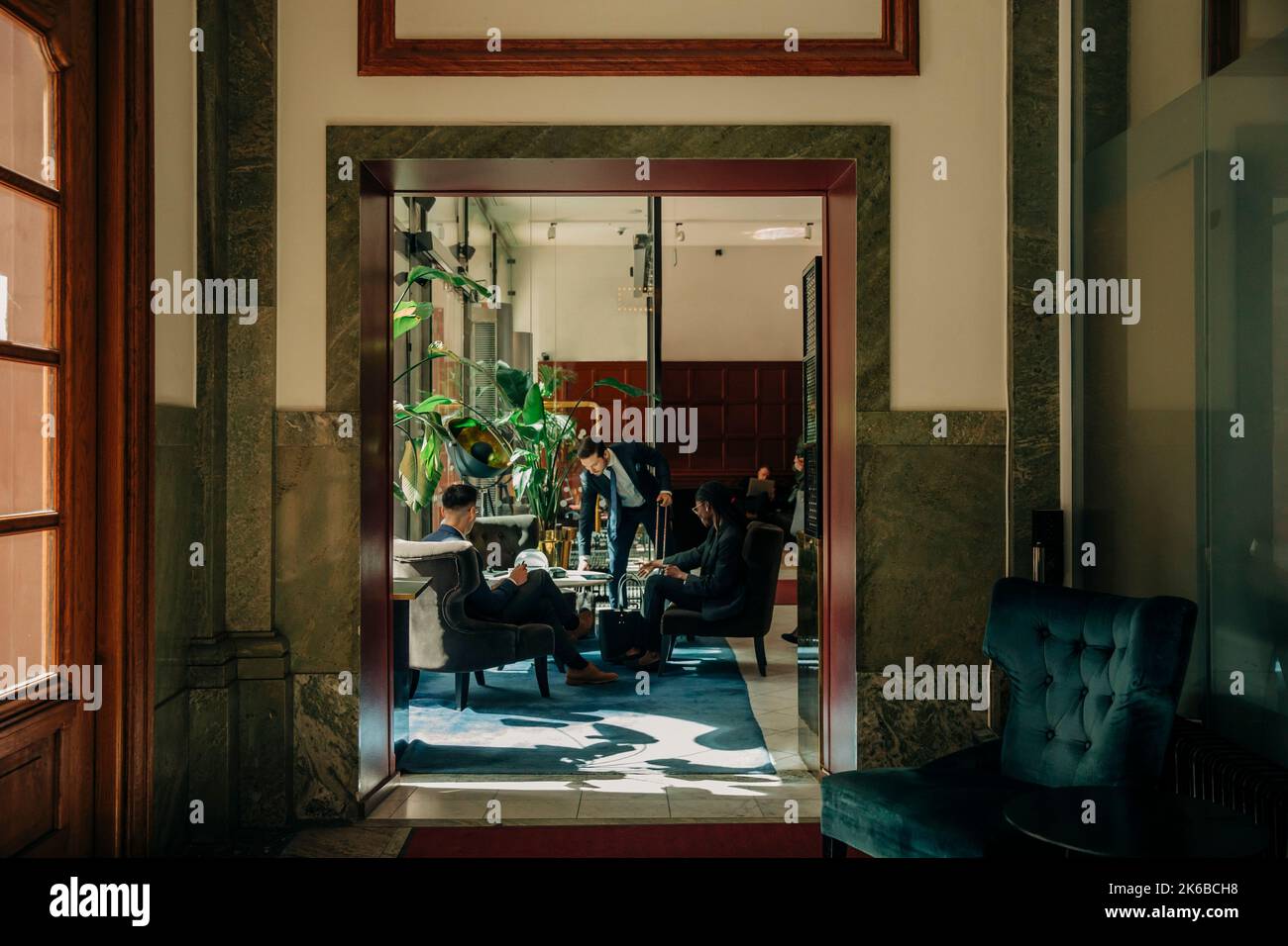 Male and female professionals in hotel lounge Stock Photo - Alamy