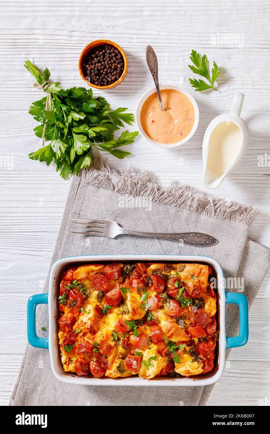 english muffin sausage breakfast casserole in baking dish on white ...