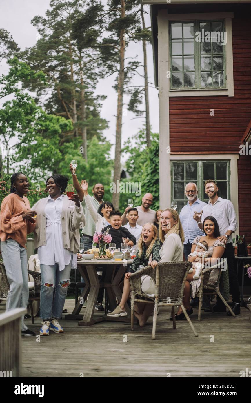 Happy multi-generation family enjoying birthday party on porch Stock ...