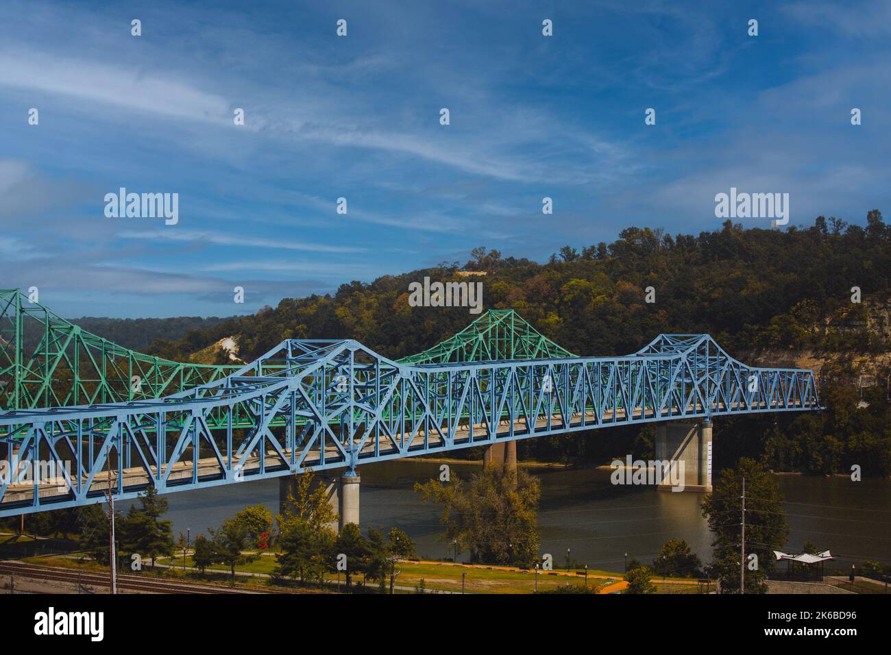A scenic shot of the blue Owensboro Bridge against the green valley ...