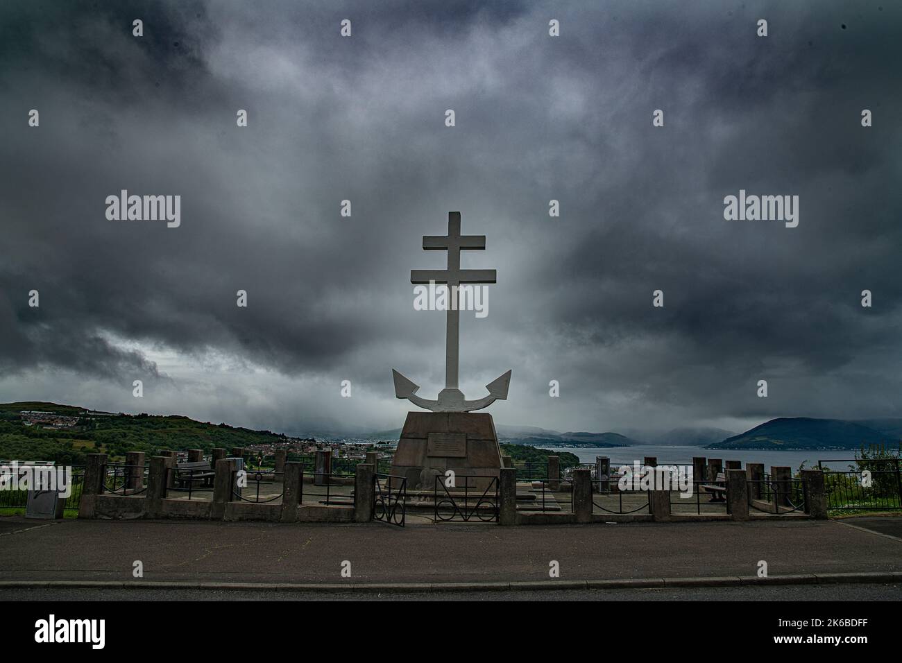 The memorial cross in Greenock against a cloudy sky with the town in ...