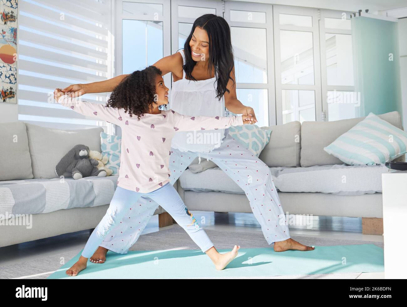 Youre doing so well. a young mother and daughter doing yoga at home ...