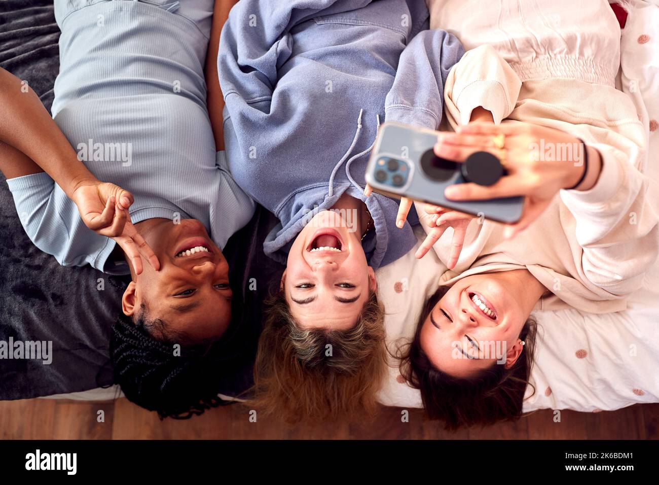 Overhead Shot Of Multi-Cultural Teenage Girl Friends Posing For Selfie ...