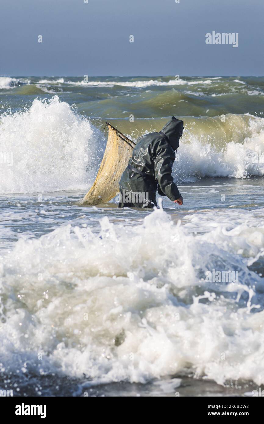 Amber catching in the Baltic Sea. Amber catcher or fisherman with ...