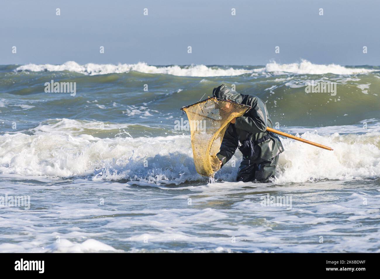 Amber catching in the Baltic Sea. Amber catcher or fisherman with ...