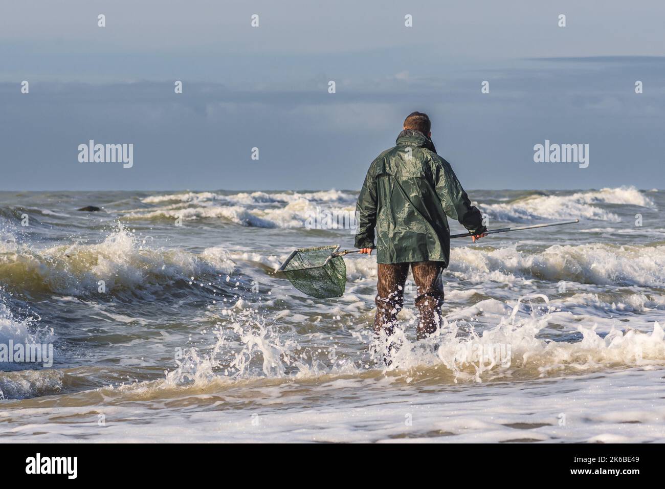 Amber catching in the Baltic Sea. Amber catcher or fisherman with ...