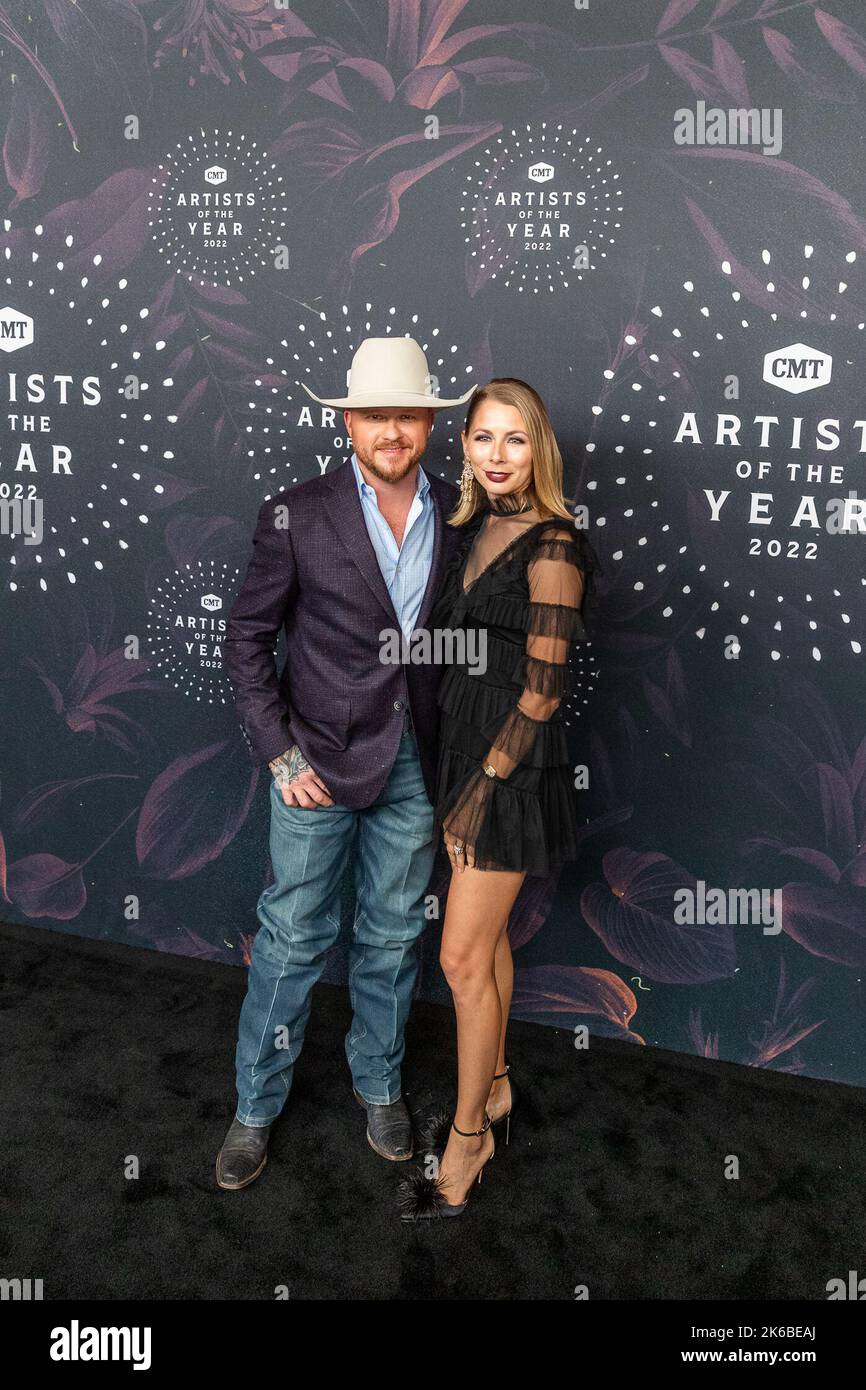 Cody Johnson (R) and his wife Brandy (L) walk the arrival carpet at the ...