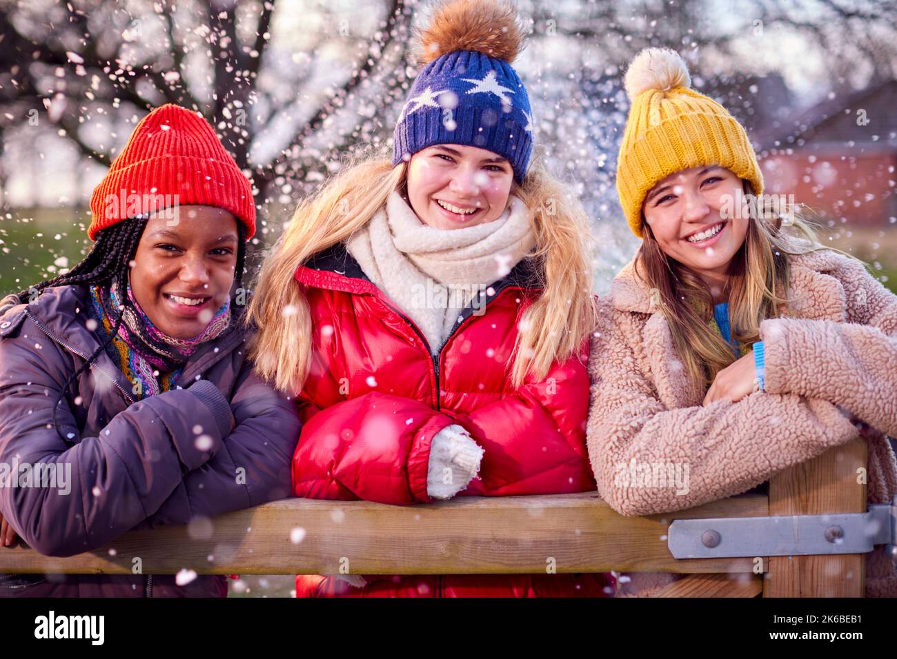 Portrait Of Teenage Girls Enjoying Snowy Winter Walk In Countryside ...