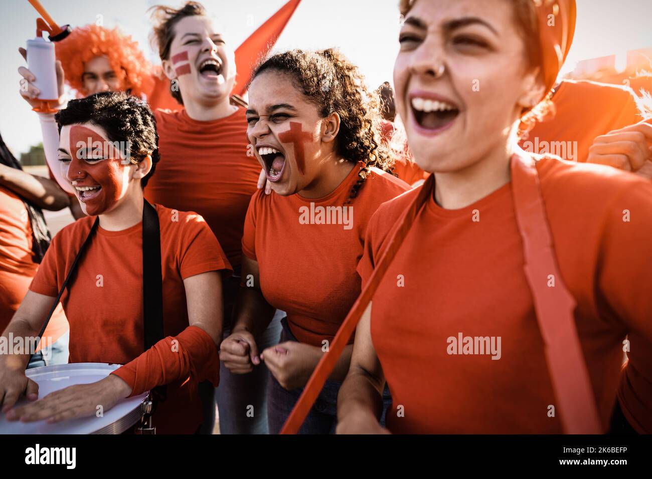 Football fans exulting while watching soccer game at stadium - Women ...