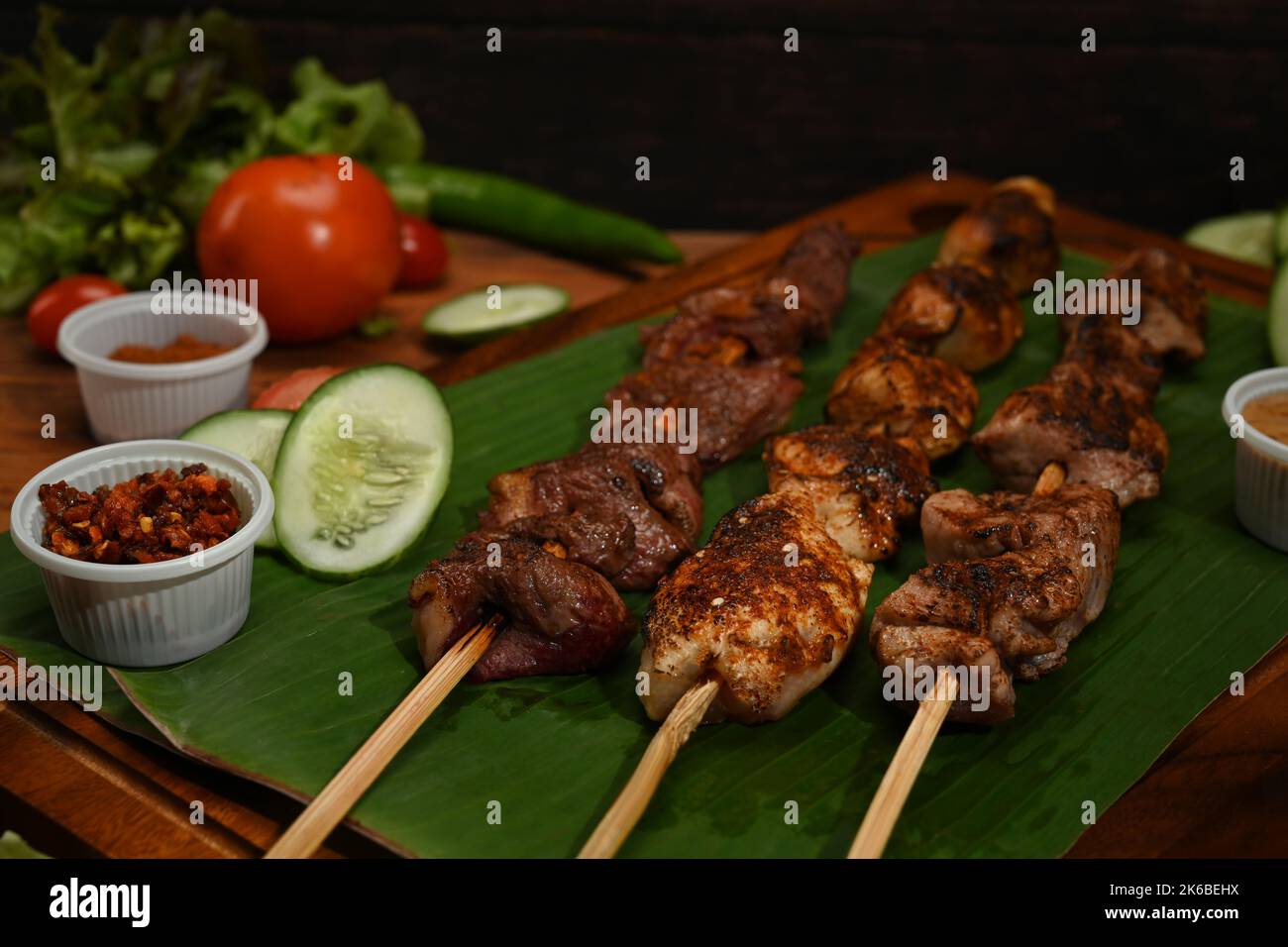Delicious grilled meat with Sichuan pepper on wood board. Mala Chinese ...