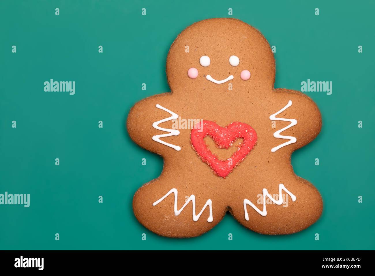 Christmas Gingerbread man sugar cookie in humanoid shape with red heart ...