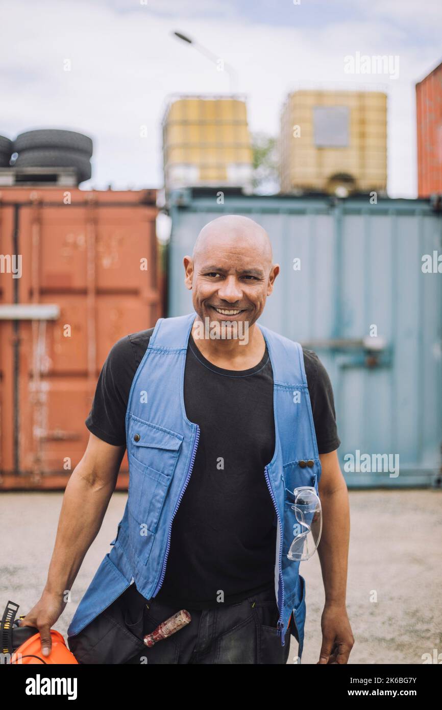 Happy bald construction worker walking at site Stock Photo - Alamy