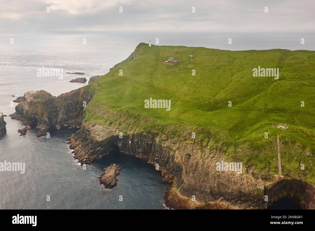 Mykines lighthouse and cliffs on Faroe islands from helicopter. Denmark ...