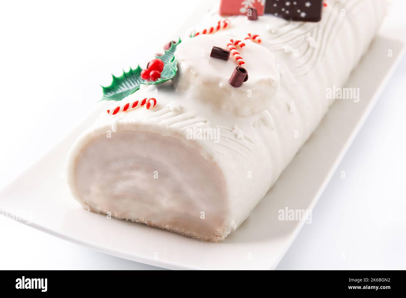 White chocolate yule log cake with christmas ornament isolated on white ...