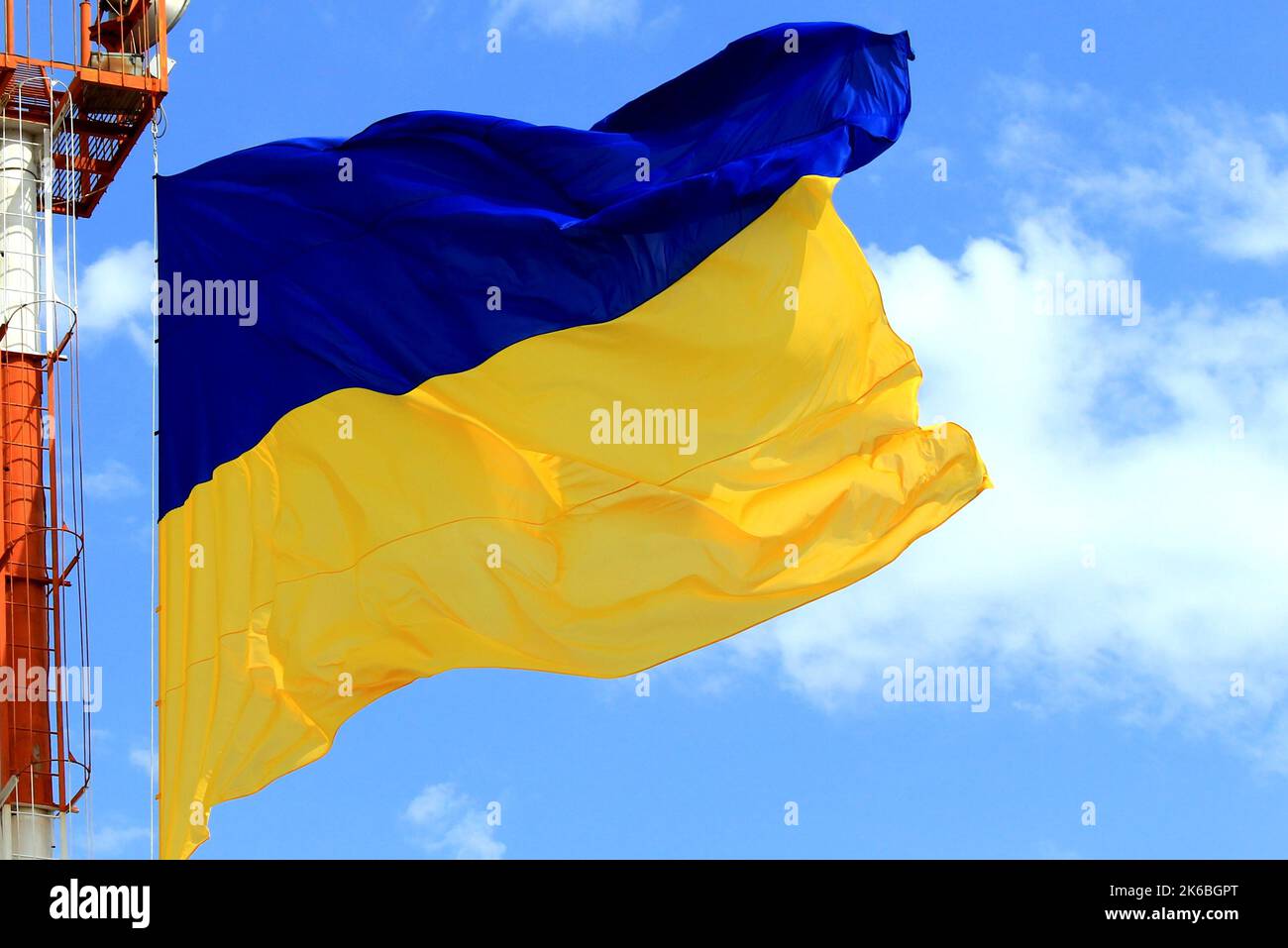 Flag of Ukraine flutters in blue sky. Large yellow blue Ukrainian ...