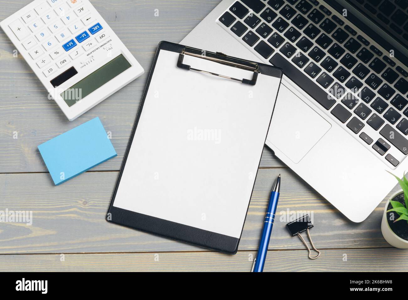 Clipboard with blank paper for copy space and supplies on wooden table ...