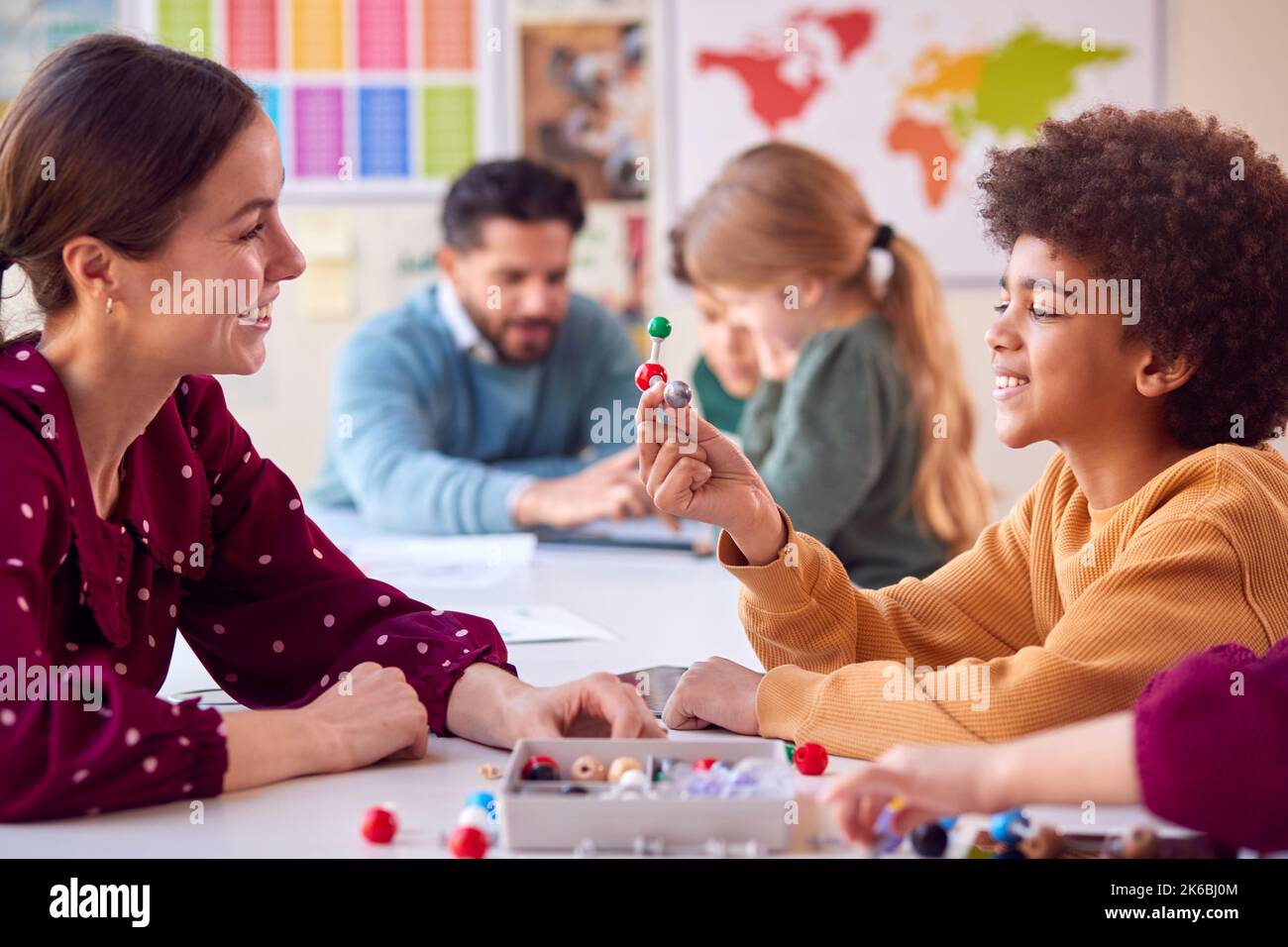 Multi-Cultural Students With Teachers In Classroom Studying Molecular ...