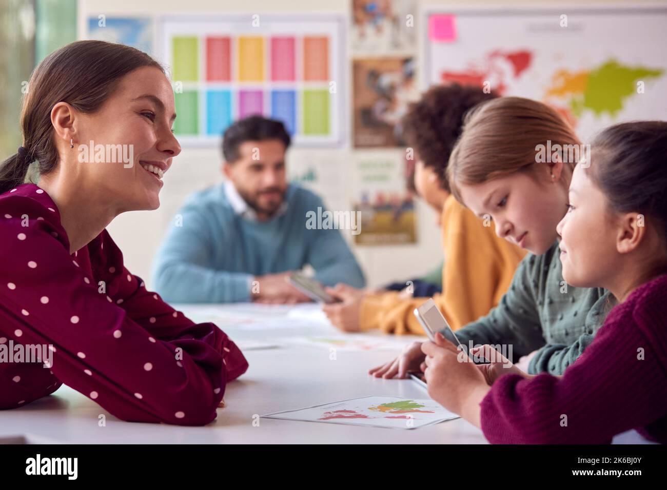 Group Of Multi-Cultural Students With Teachers In Classroom Using ...
